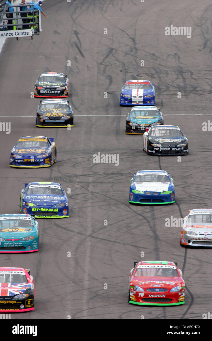 V8 Nascar type stock cars racing on a banked oval circuit Stock Photo ...