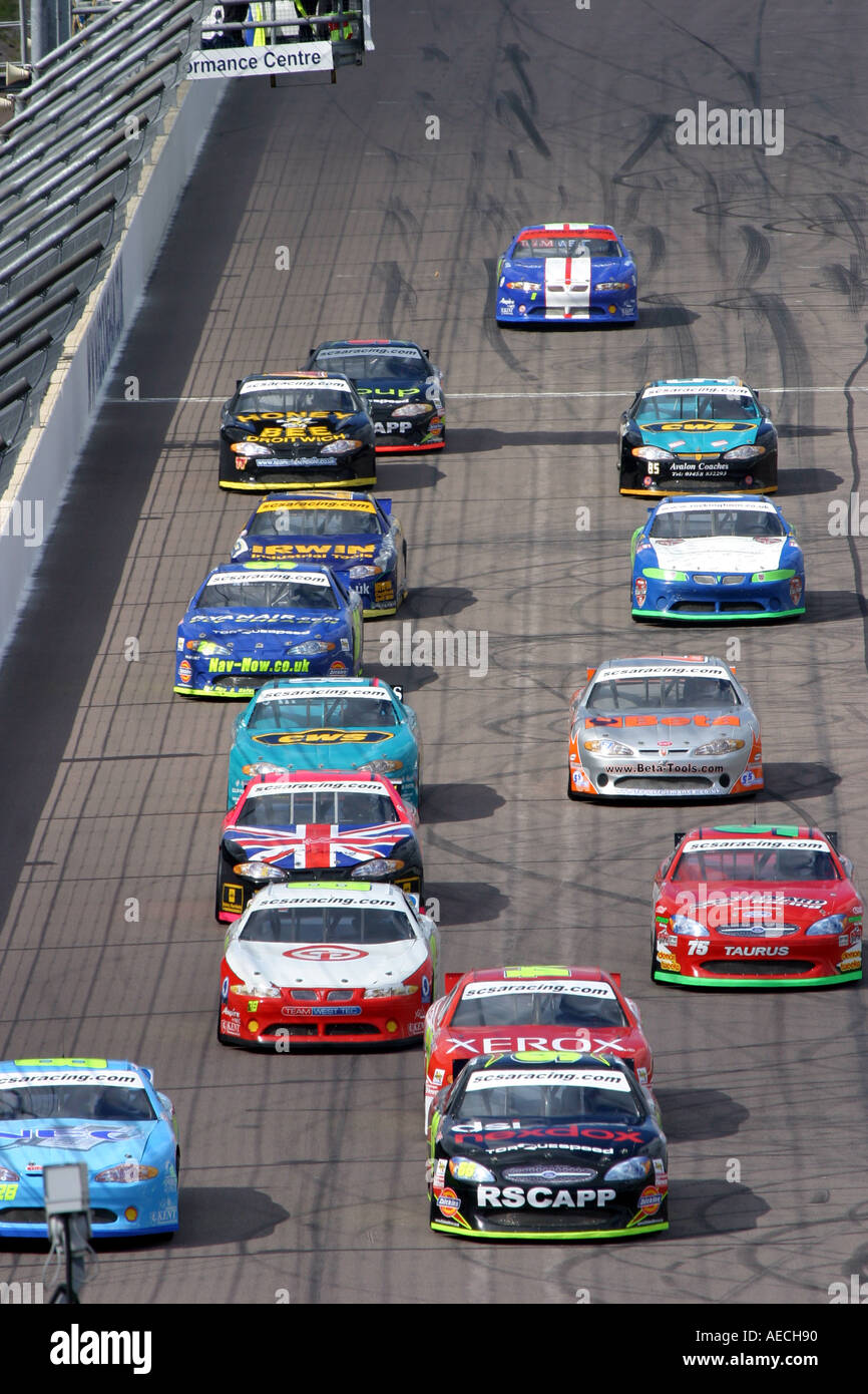 V8 Nascar type stock cars racing on a banked oval circuit Stock Photo ...