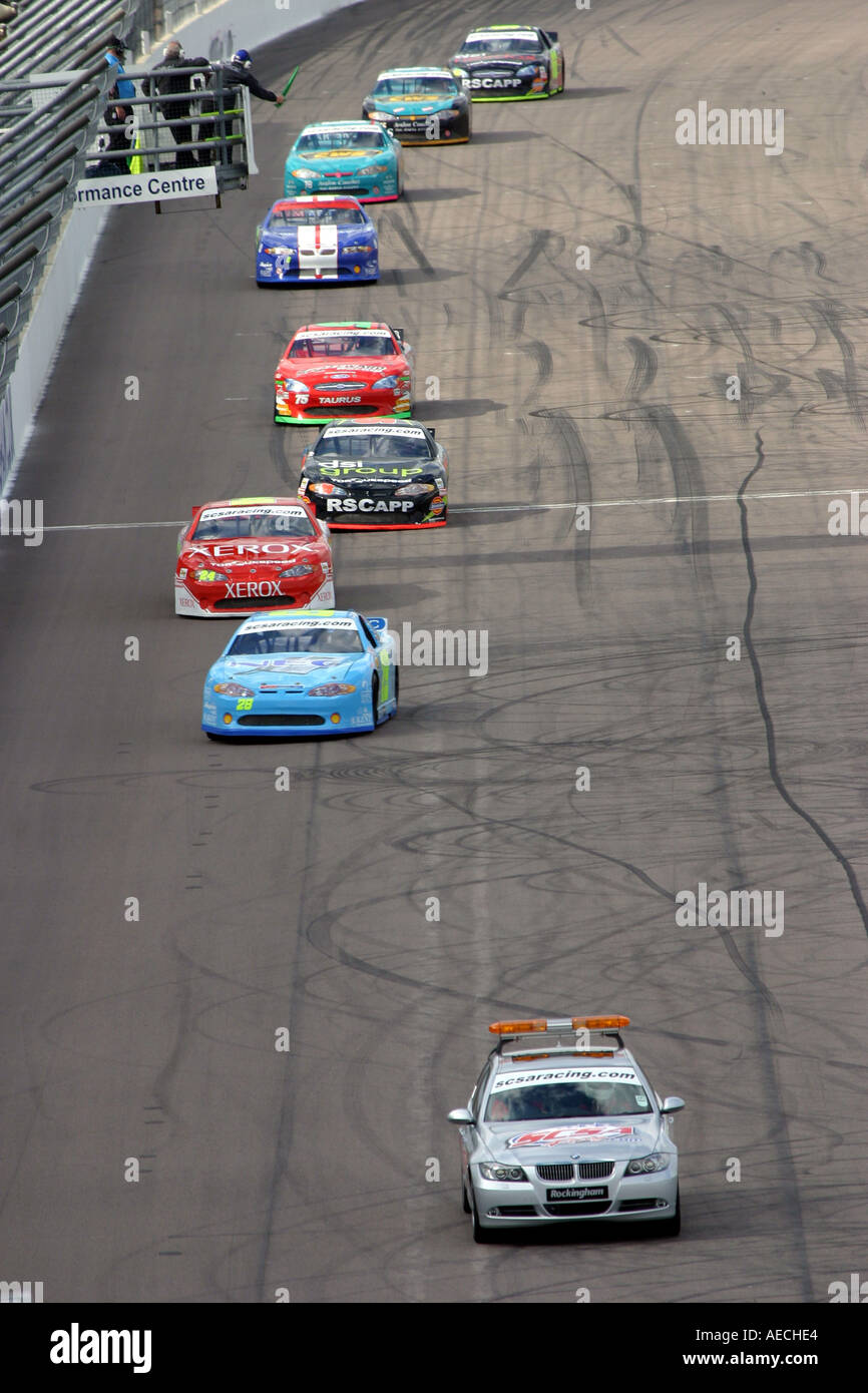 V8 Nascar type stock cars racing on a banked oval circuit Stock Photo ...