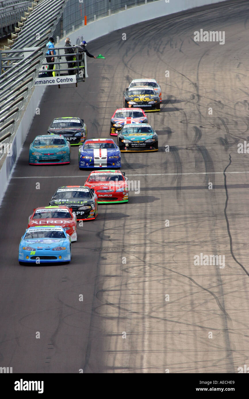 V8 Nascar type stock cars racing on a banked oval circuit Stock Photo ...