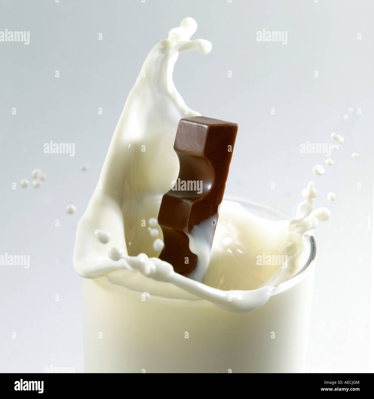 Chocolate falling in milk splashing hi-res stock photography and images ...