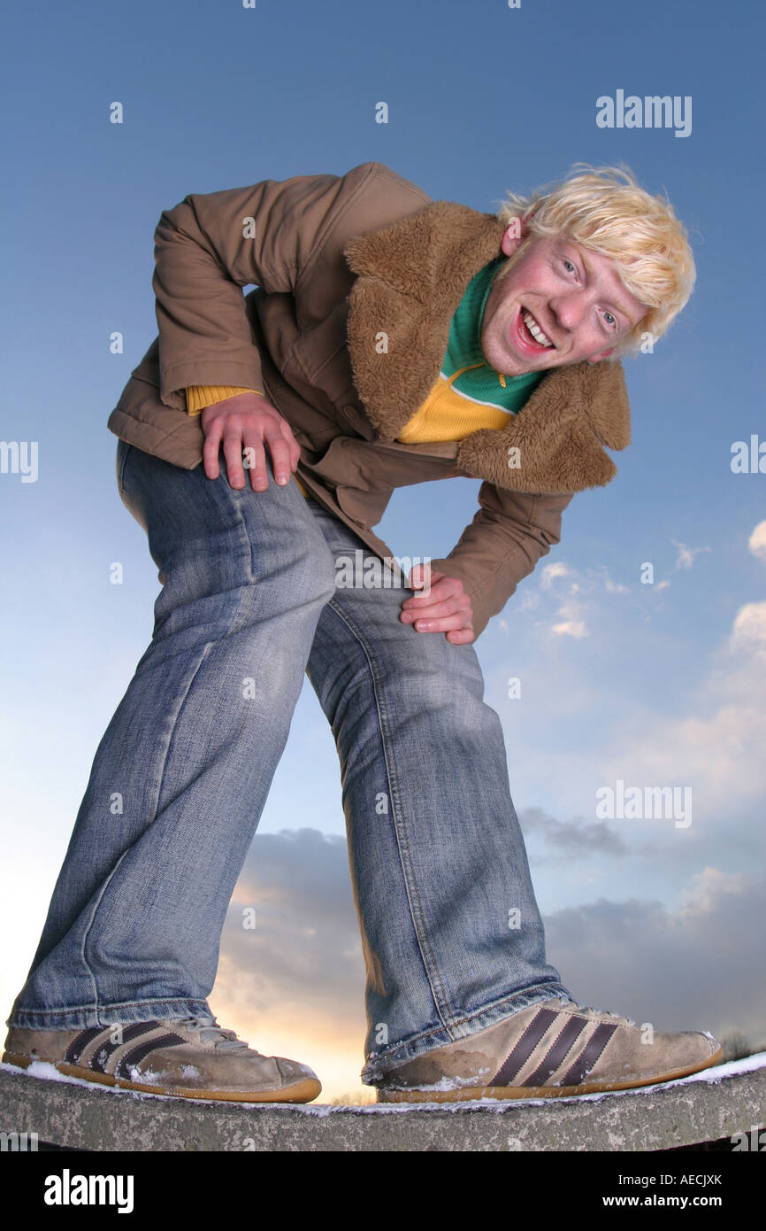 bending down young man Stock Photo - Alamy