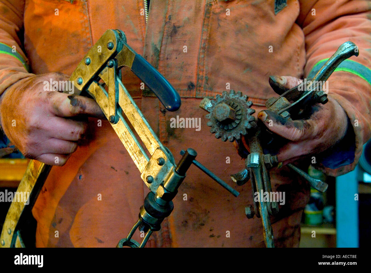 mechanic holding tools in his hands Stock Photo - Alamy