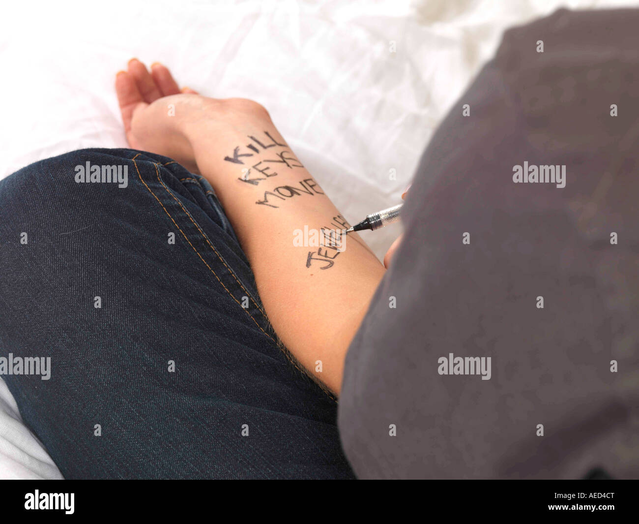 Teenage Girl Writing on her Wrists Model Released Stock Photo - Alamy