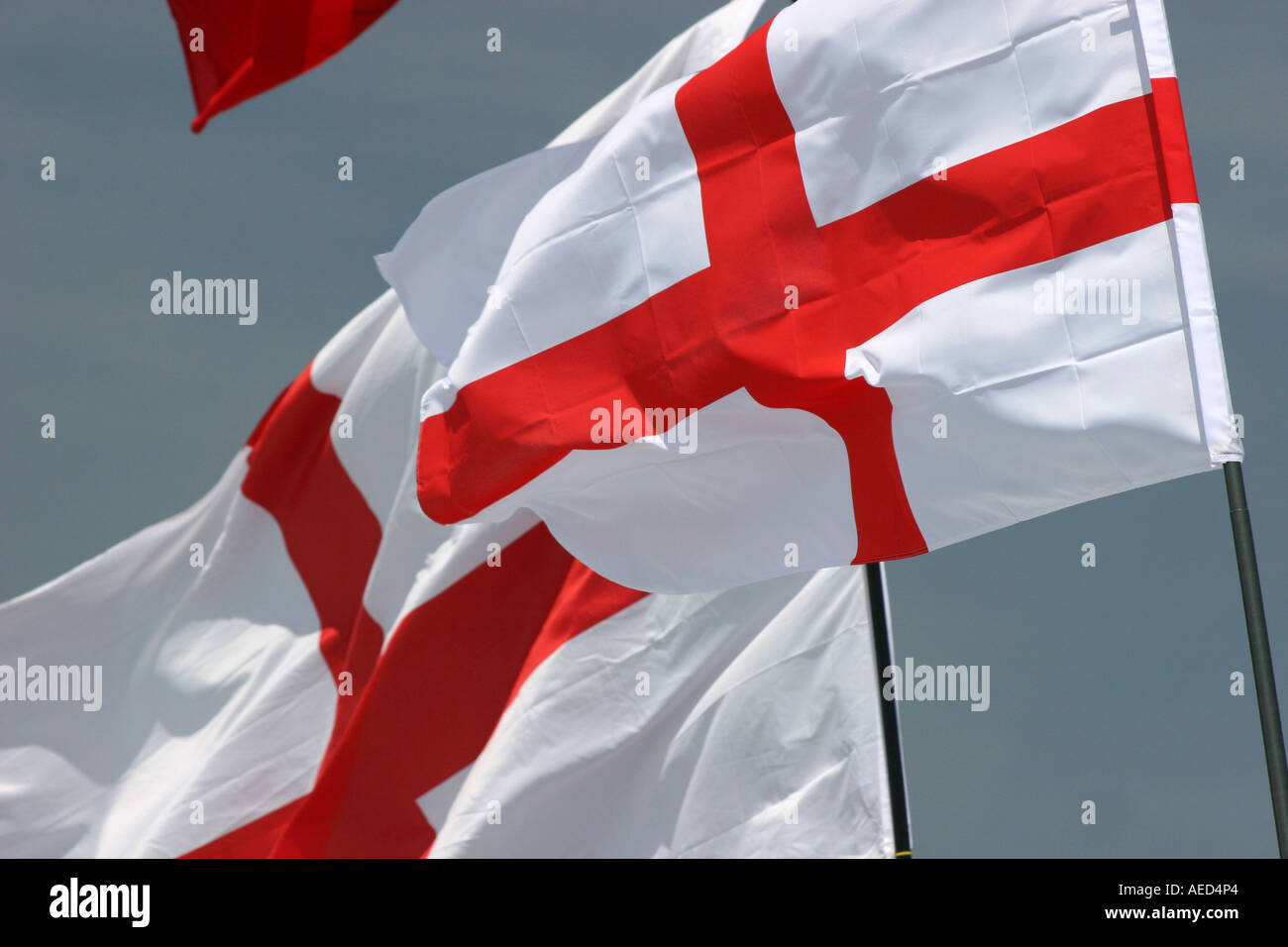 Pair of St George's flags flying in the wind Stock Photo - Alamy