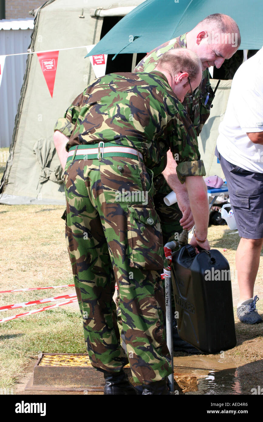 Filling up a water container Stock Photo - Alamy