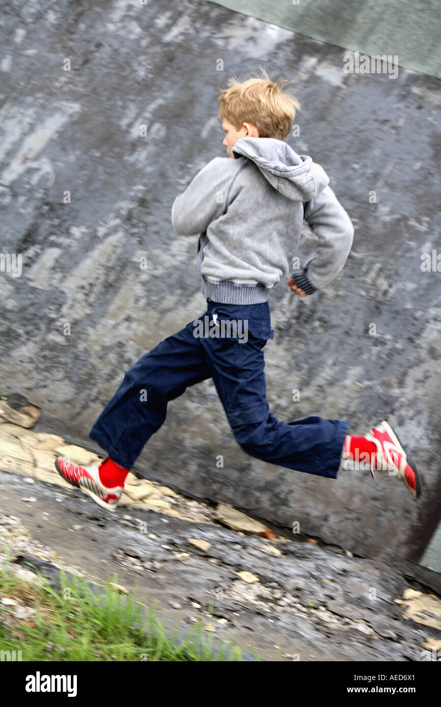 Vertical full length portrait on a tilt angle of young boy in full ...
