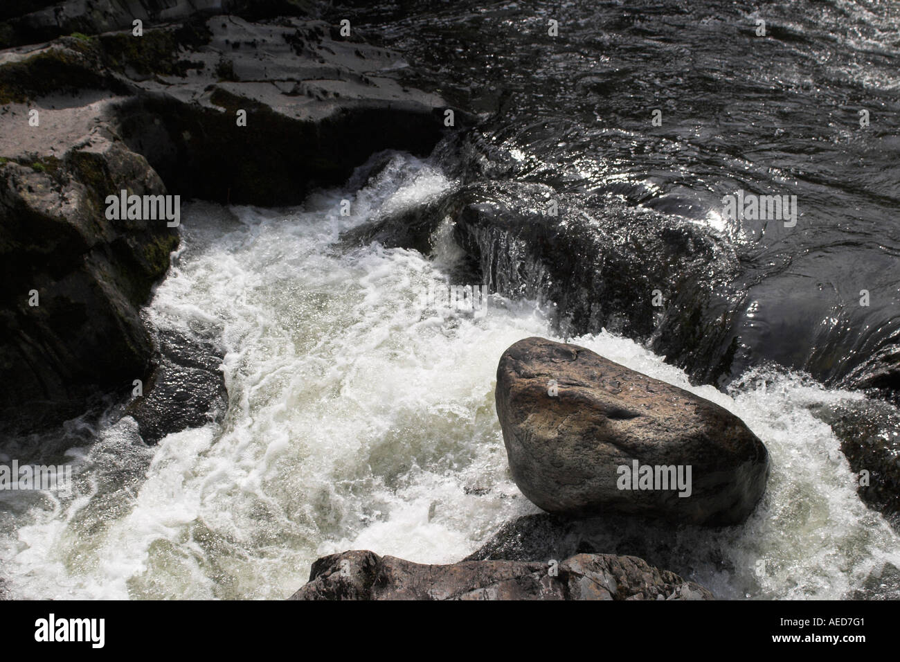 Mountain stream rushing over rocks Stock Photo - Alamy