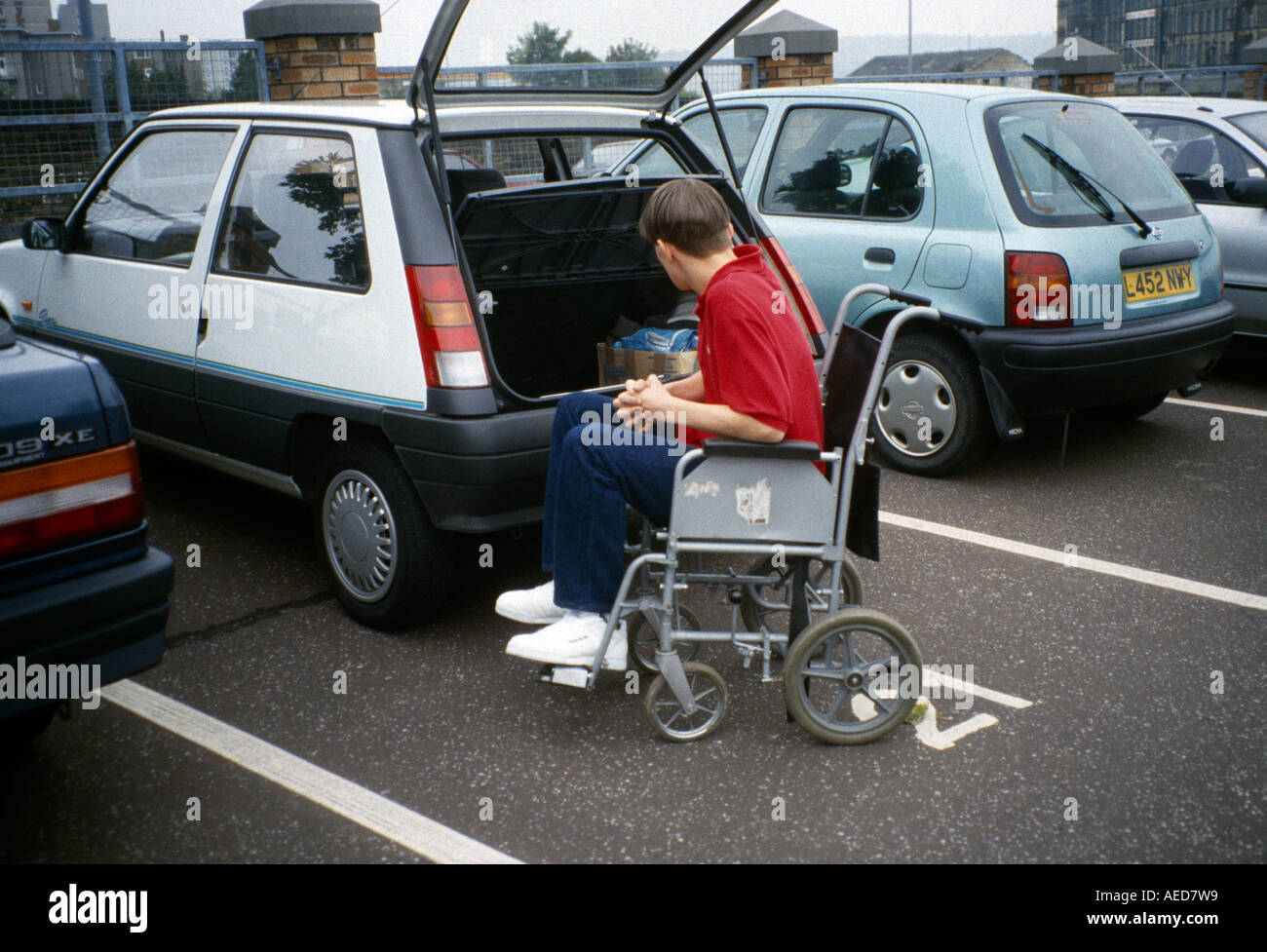 Young Man in Wheelchair Loading Boot of Car Stock Photo - Alamy