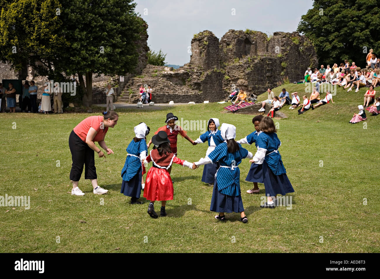 Teacher and ethnic background children in traditional costume country ...