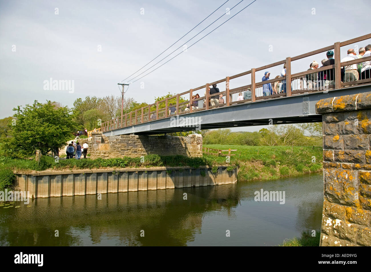 walkers crossing new footbridge and cycle path over the River Stour in ...