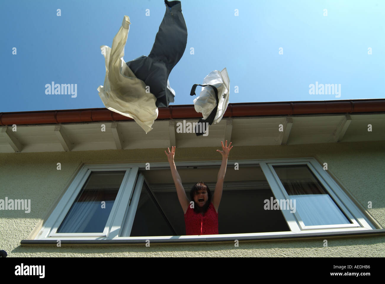 Woman throw clothes out of window hi-res stock photography and images ...