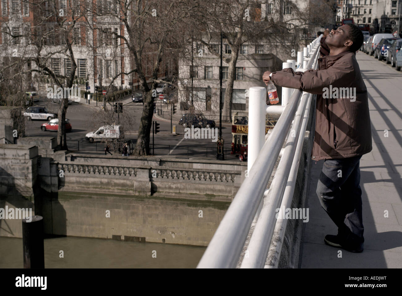 Man relaxing against railings Stock Photo - Alamy