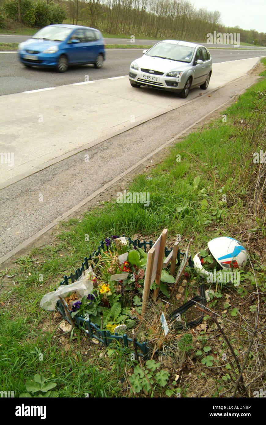 Cars passing by a roadside memorial to a fatal accident Stock Photo - Alamy