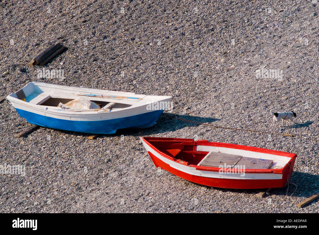 Bright red and blue boats on a beach Stock Photo - Alamy