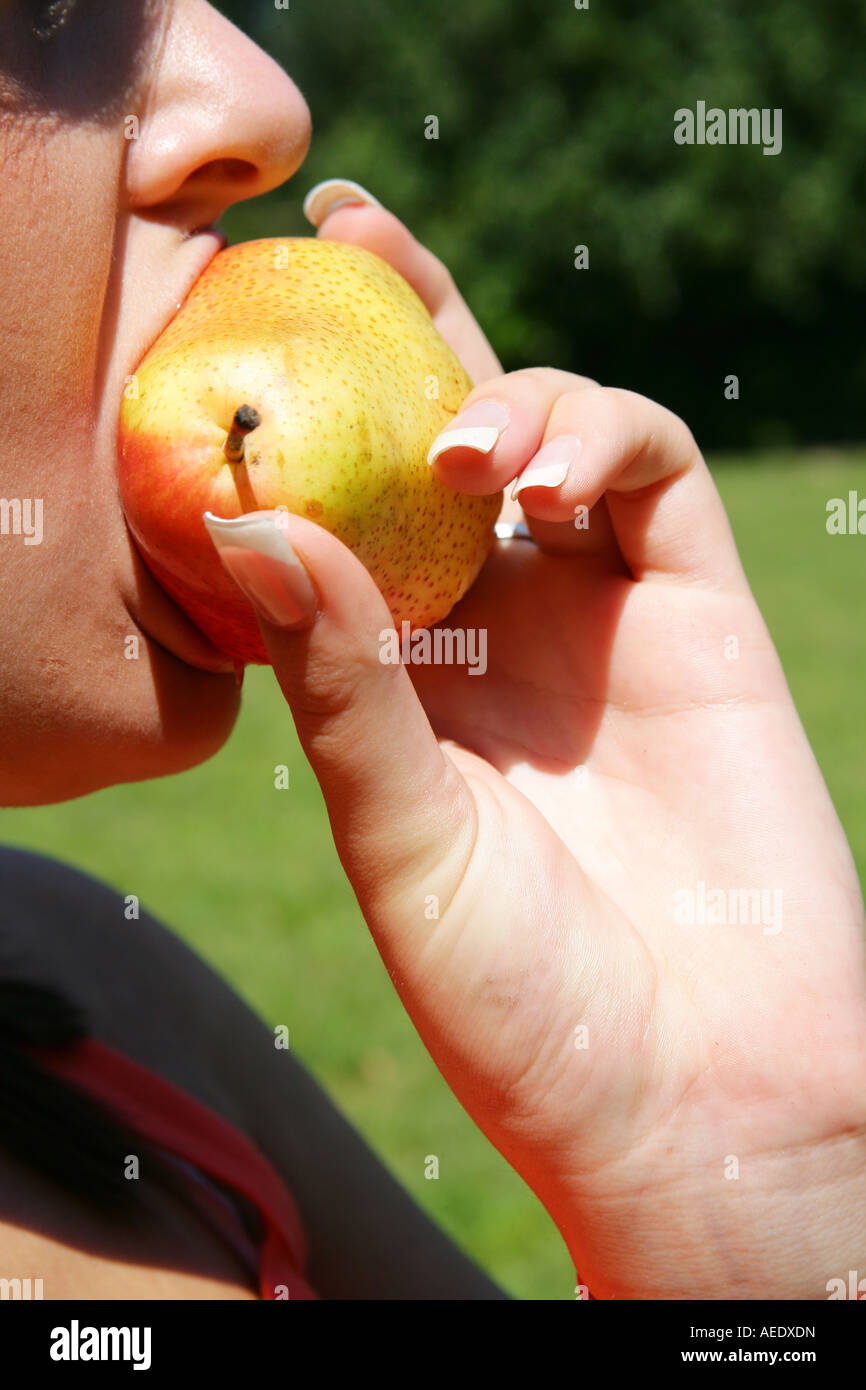 Teenager Eating a Pear Model Released Stock Photo - Alamy