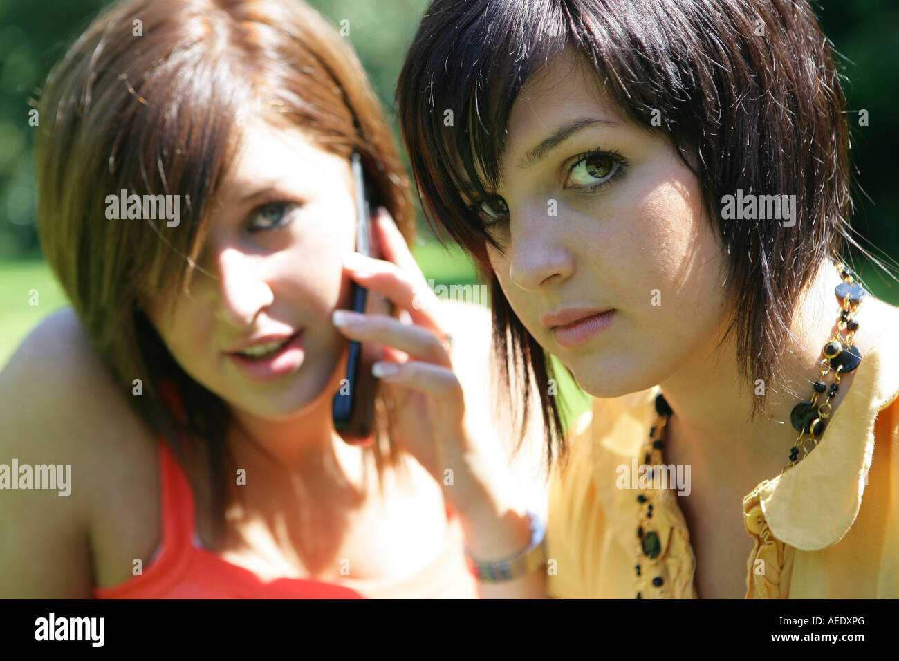 Two Women Using Mobile Phone Model Released Stock Photo - Alamy