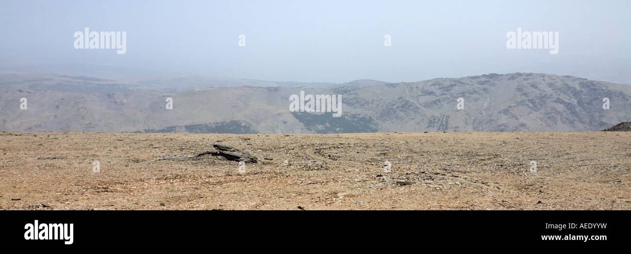 Dry rocky slope of Loma de Mulhacen and Sierra Nevada mountains looking ...