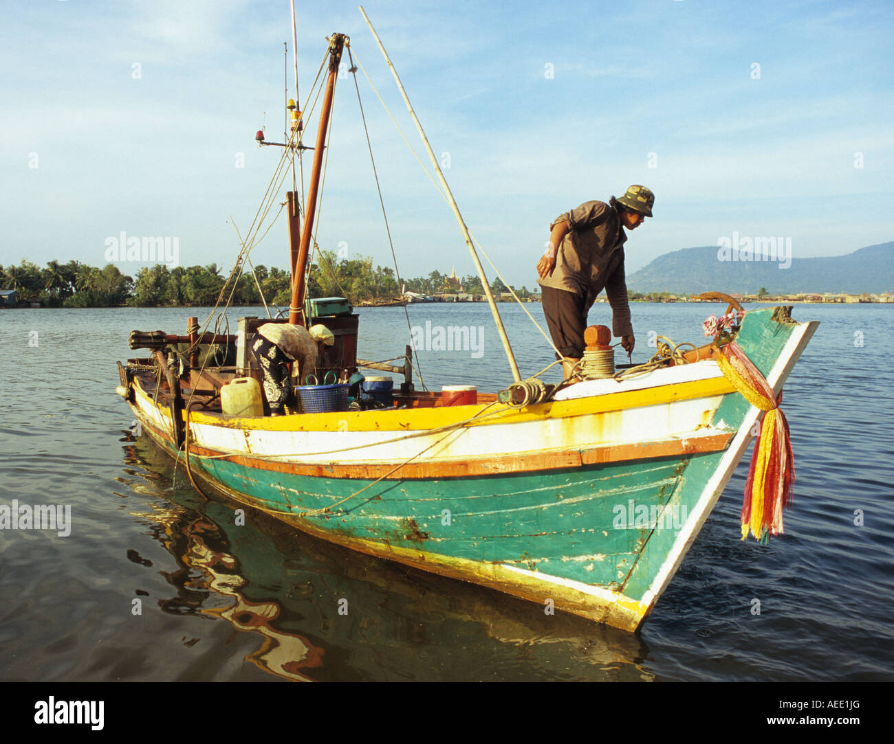 Cham fisherman on a fishing boat on the Sanke river, Kampot, Cambodia ...