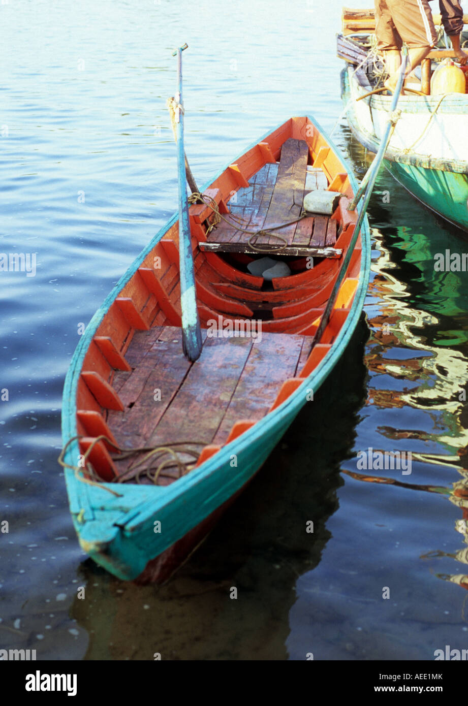 Brightly painted blue and orange rowing boat on the Sanke river, Kampot ...