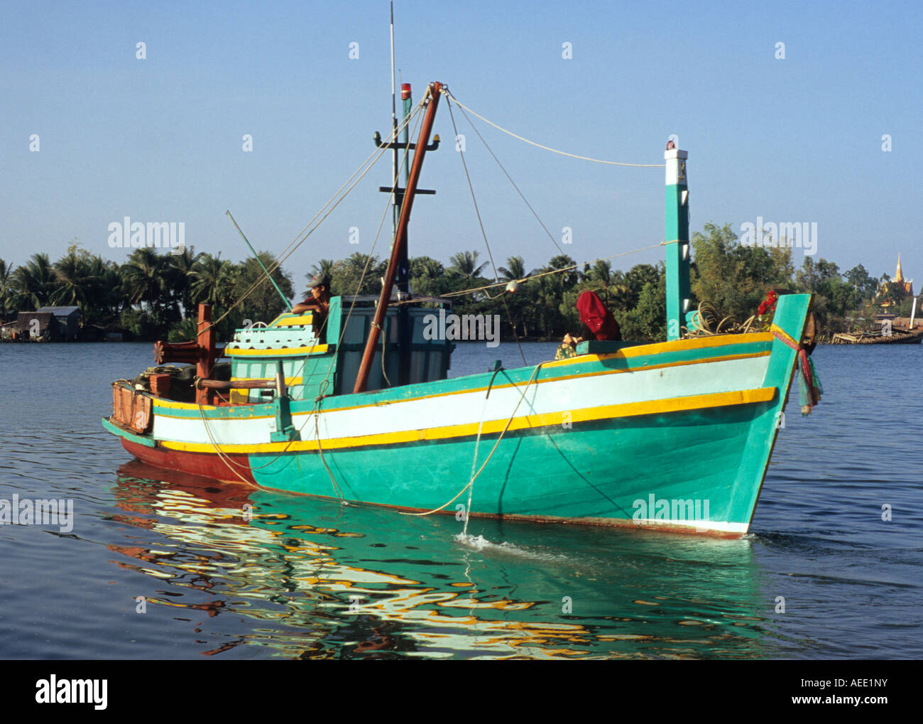 Traditional Cham fishing boat reflected in ripples on the Sanke river ...