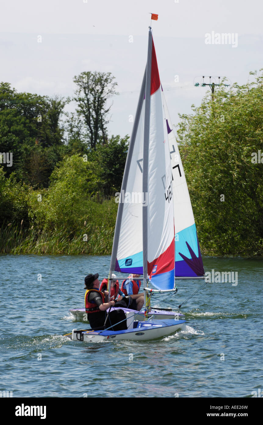 Two Topper sailing dinghies cross each others path Stock Photo - Alamy