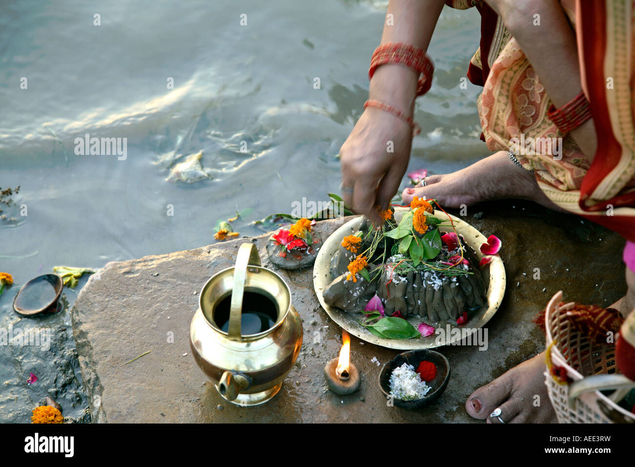 Woman performing ritual puja ceremony. Shivala Ghat. Ganges river ...