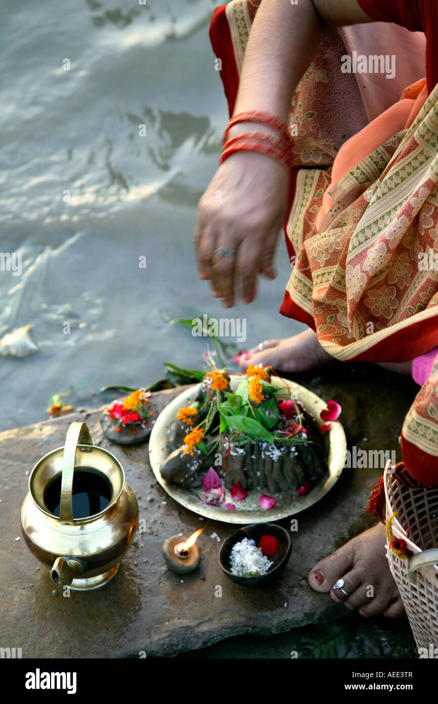 Woman performing ritual puja ceremony. Shivala Ghat. Ganges river ...