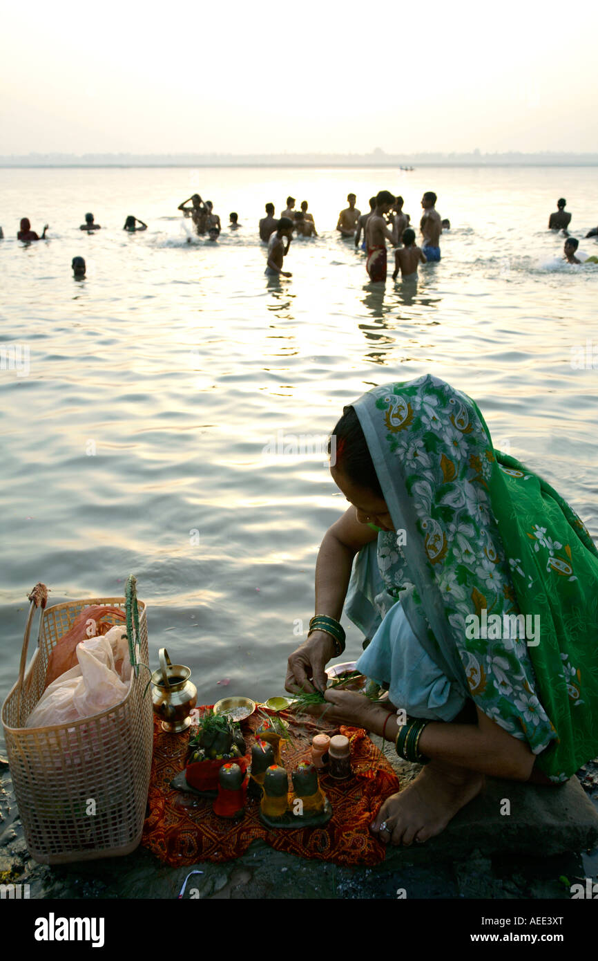 Woman performing ritual puja ceremony. Shivala Ghat. Ganges river ...