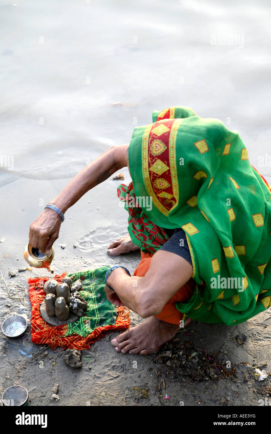 Woman performing ritual puja ceremony. Shivala Ghat. Ganges river ...