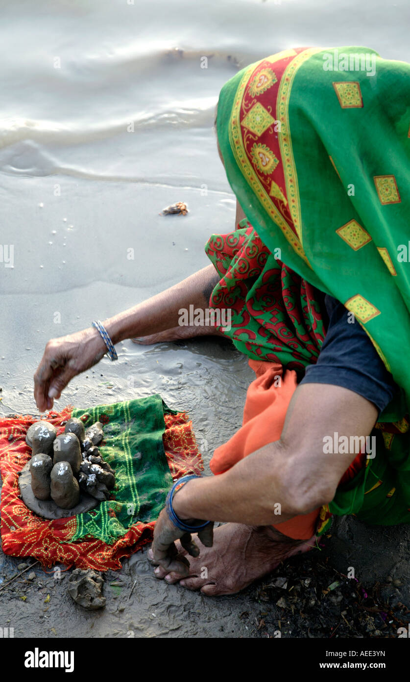 Woman performing ritual puja ceremony. Shivala Ghat. Ganges river ...