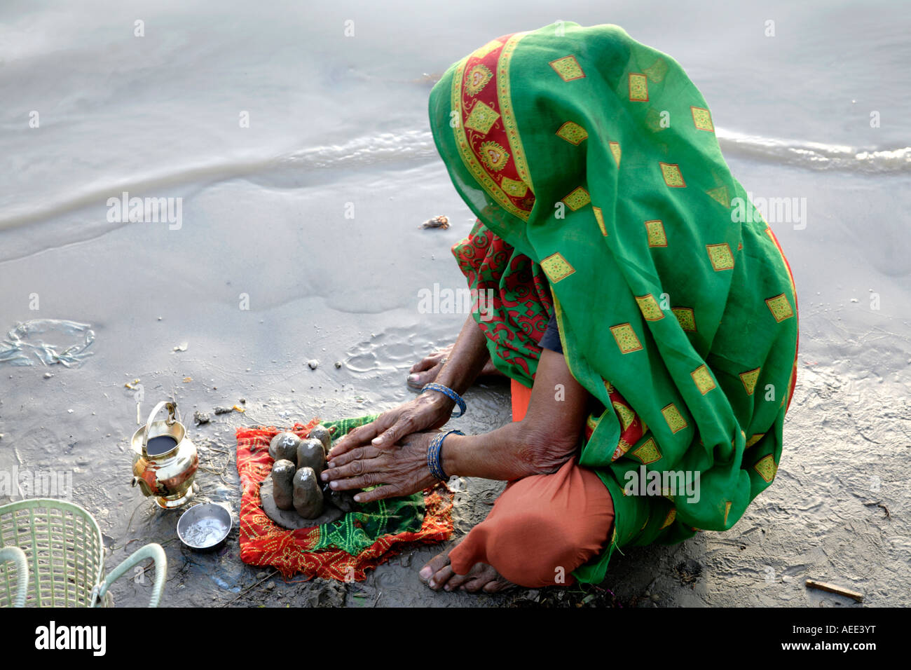 Woman performing ritual puja ceremony. Shivala Ghat. Ganges river ...