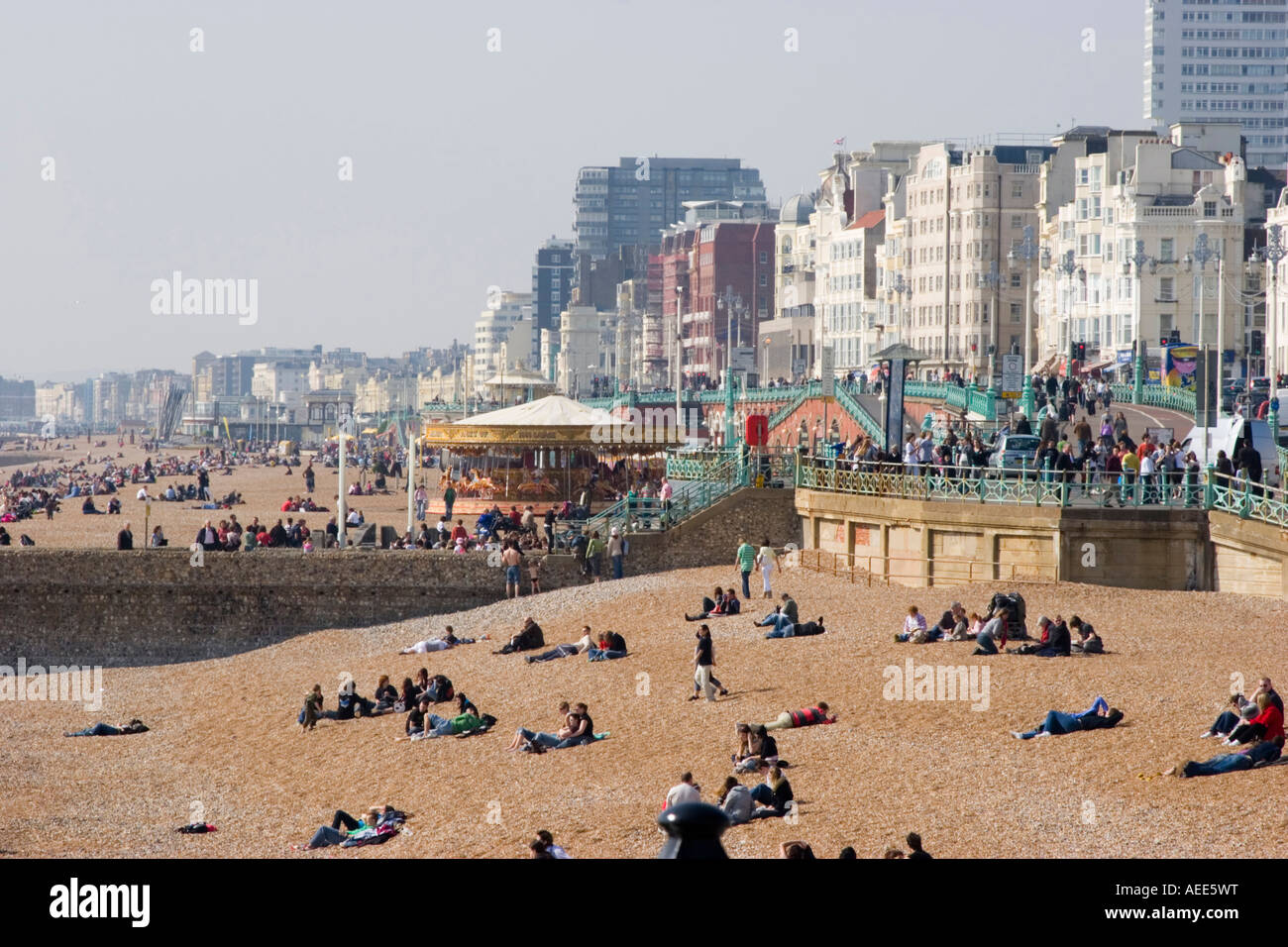A busy and crowded Brighton beach and sea front on an unseasonably warm ...