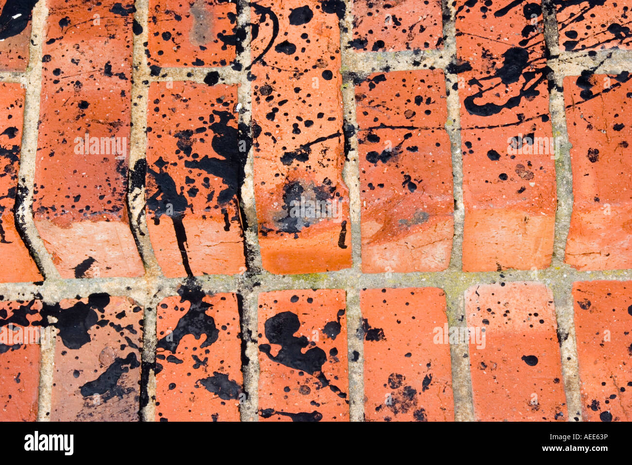 Red brick steps splattered with black tar paint Stock Photo - Alamy