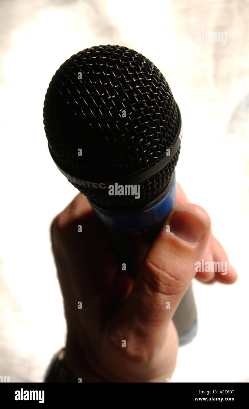Microphone held in hand Stock Photo - Alamy