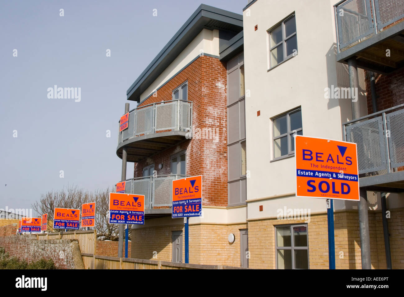 Estate agent s for sale signs outside newly built flats Stock Photo - Alamy