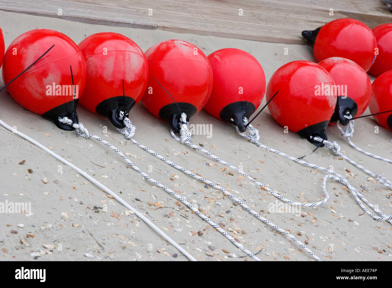 Red buoys and ropes on the quay Stock Photo - Alamy