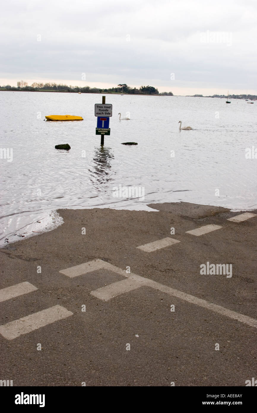 Signs warning of road flooding each high tide in Bosham Harbour West ...