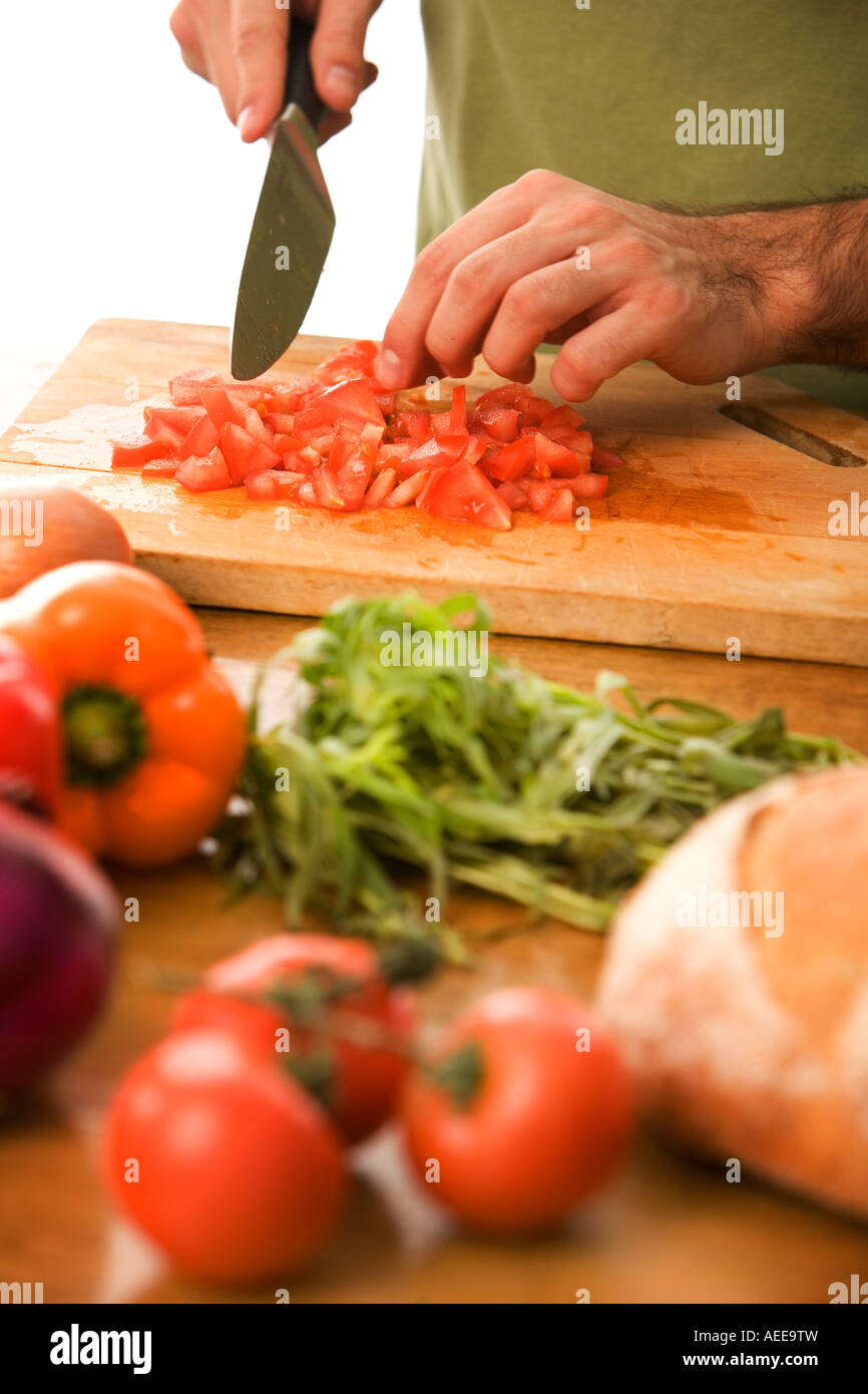 Man in studio chopping vegetables Stock Photo - Alamy