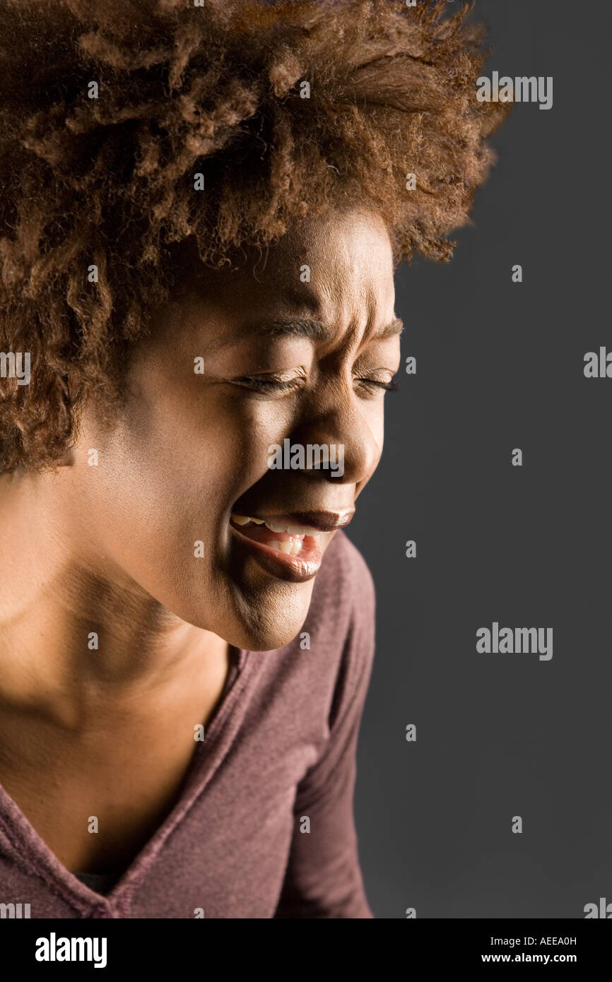 A woman with an afro crying Stock Photo - Alamy