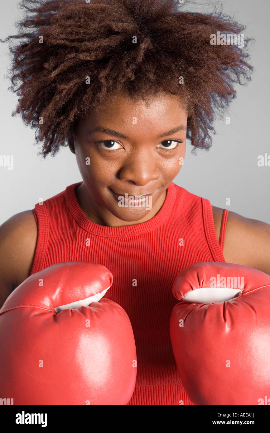 A woman in a studio with boxing gloves on Stock Photo - Alamy