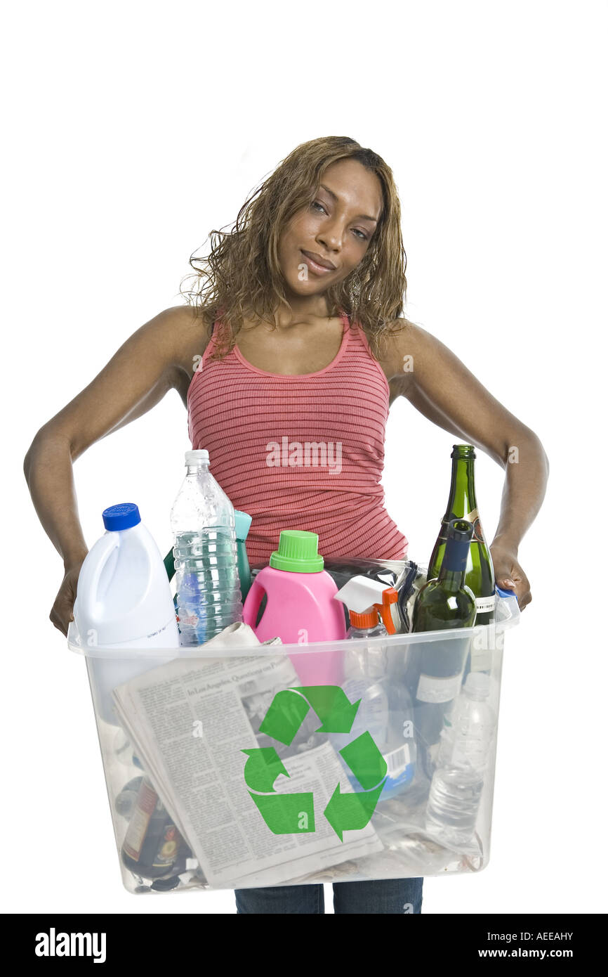 A young woman holding a recycling bin full of rubbish Stock Photo - Alamy