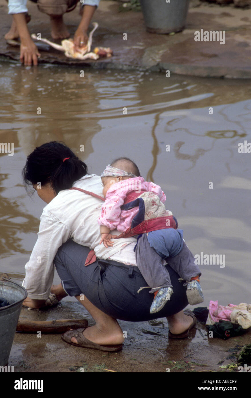 Washing clothes (and a chicken for dinner!) in the village pond in ...