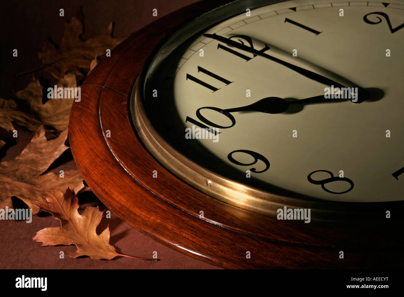 Clock face showing time with Autumn leaves Stock Photo - Alamy