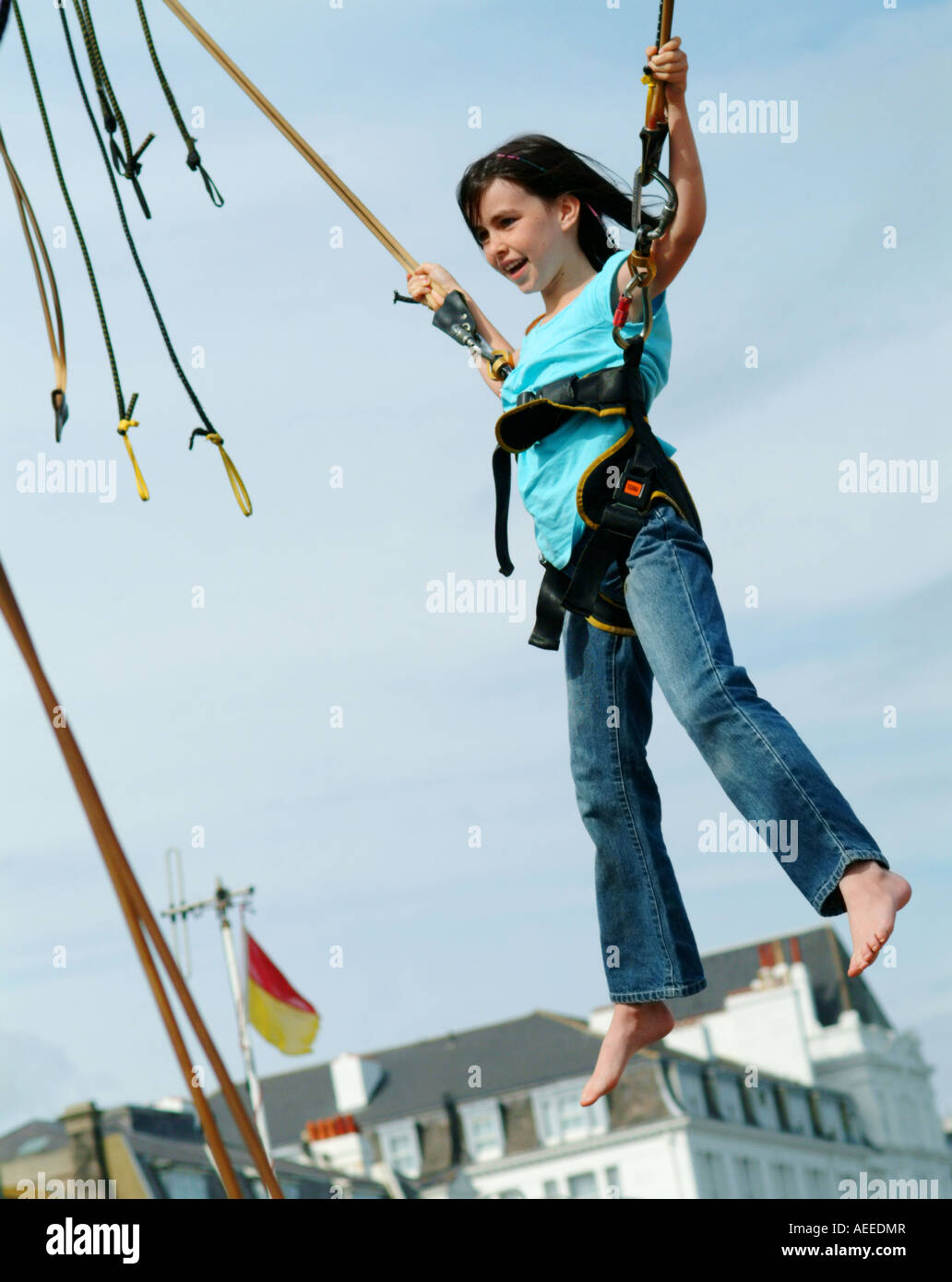 Girl bouncing on trampoline bungee hi-res stock photography and images ...