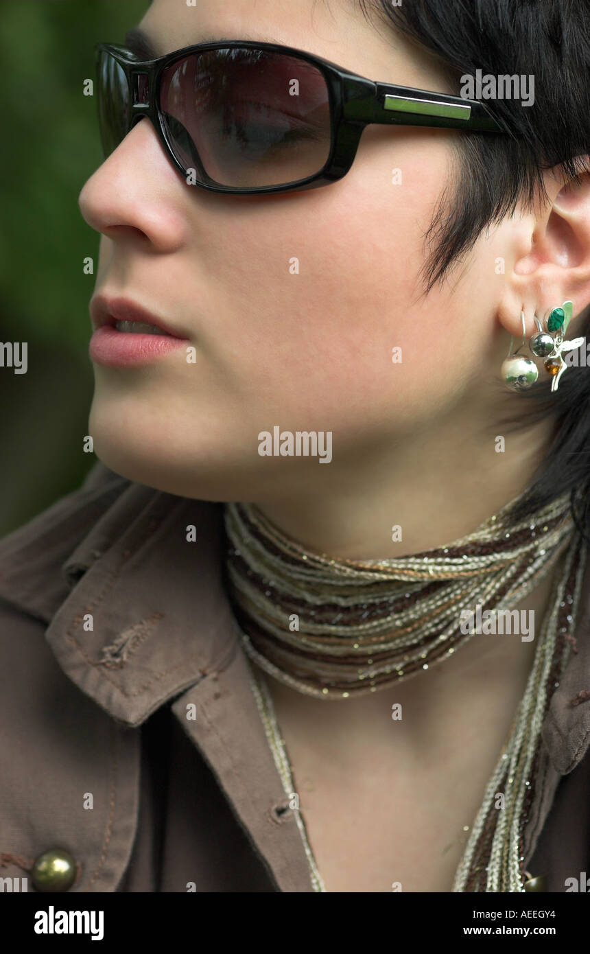 Woman wearing sunglasses earrings hi-res stock photography and images ...