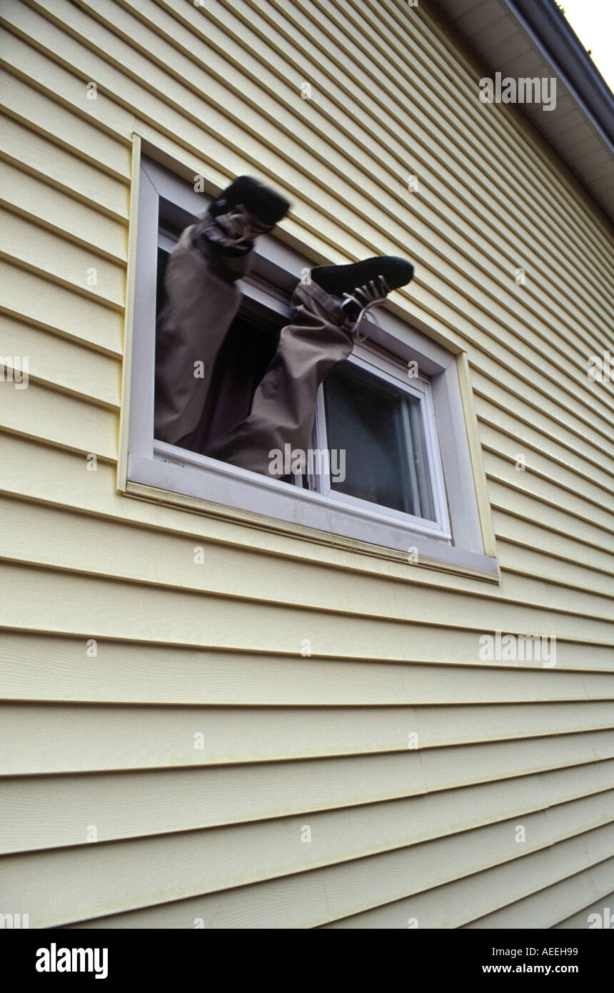 Breaking and entering a house through a small window Stock Photo - Alamy