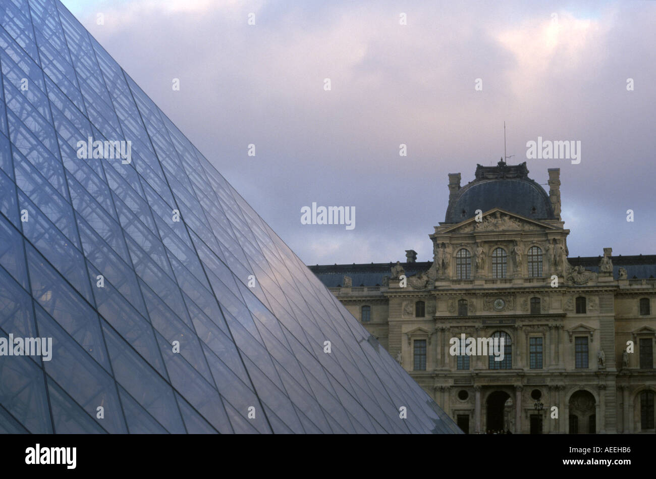 The modern glass pyramid set against classical baroque architecture in ...