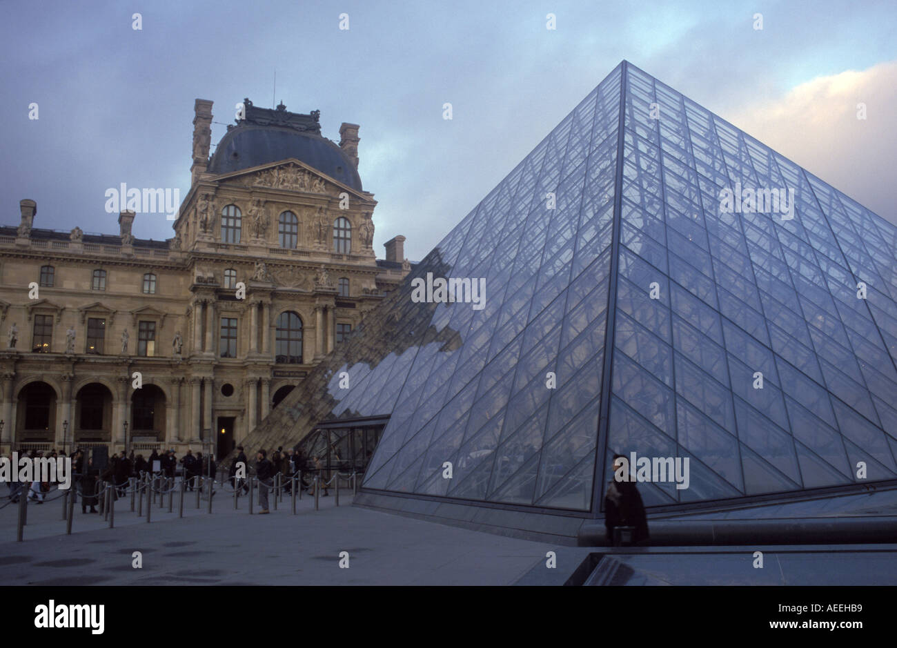 The modern glass pyramid set against classical baroque architecture in ...