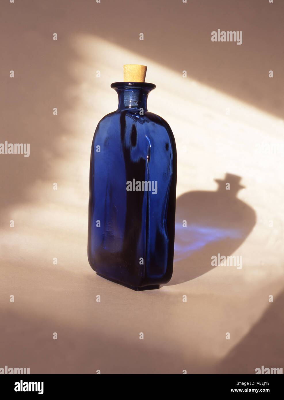 Blue Bottle casting a shadow Stock Photo - Alamy